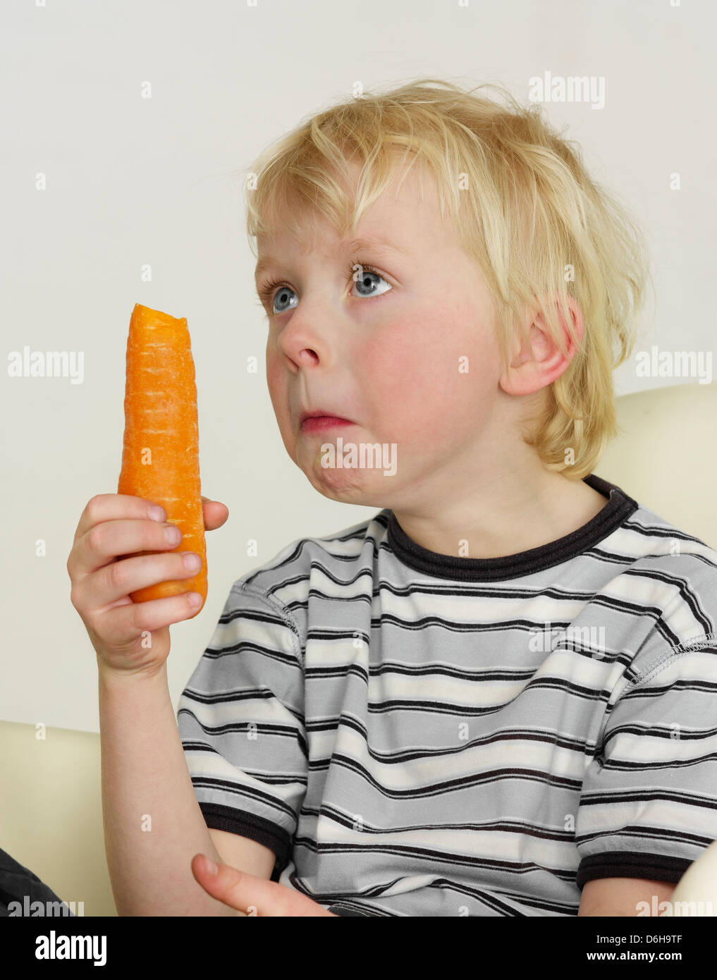 Young boy eating carrot. Model release all media Stock Photo - Alamy
