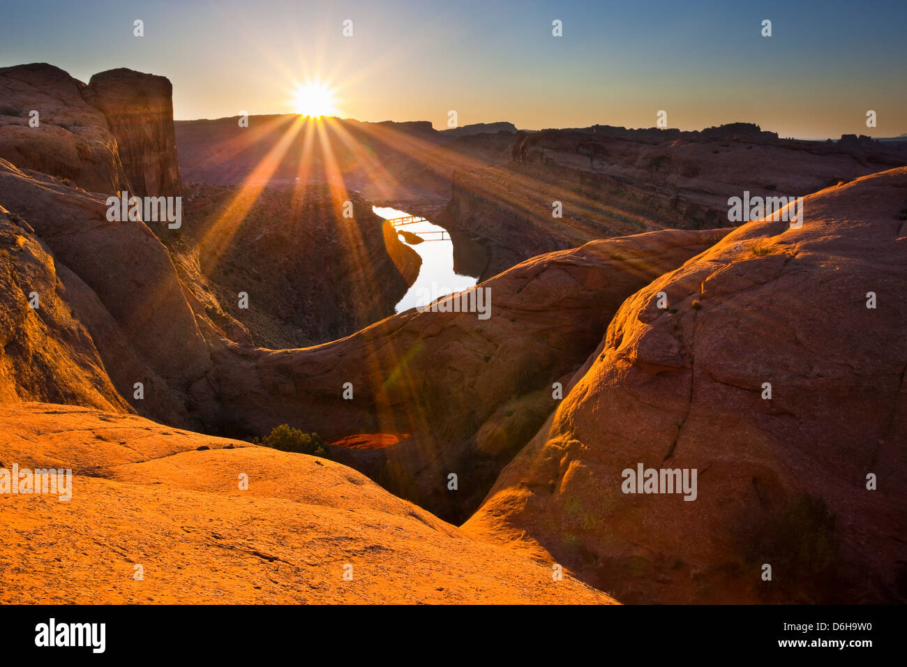 Sun rising over canyon rock formations Stock Photo - Alamy