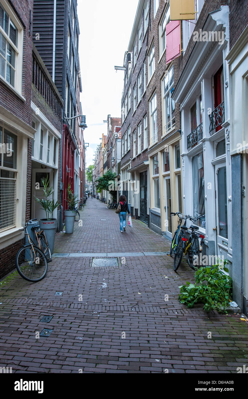 Lone girl walking along a typical side street in Amsterdam Stock Photo ...