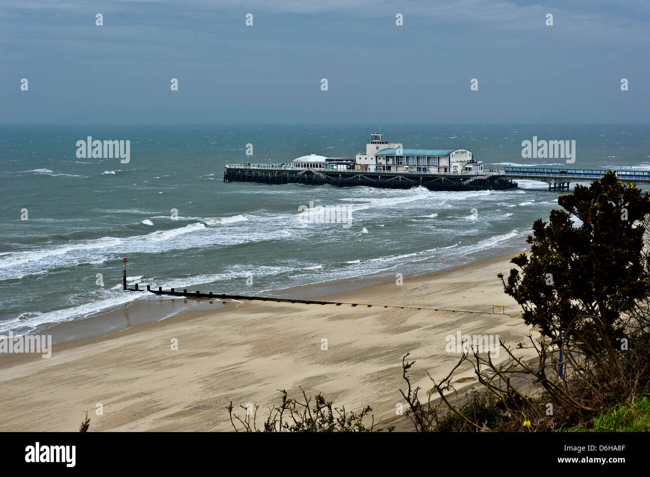 Bournemouth Pier and sea front with winter storm waves and empty beach ...