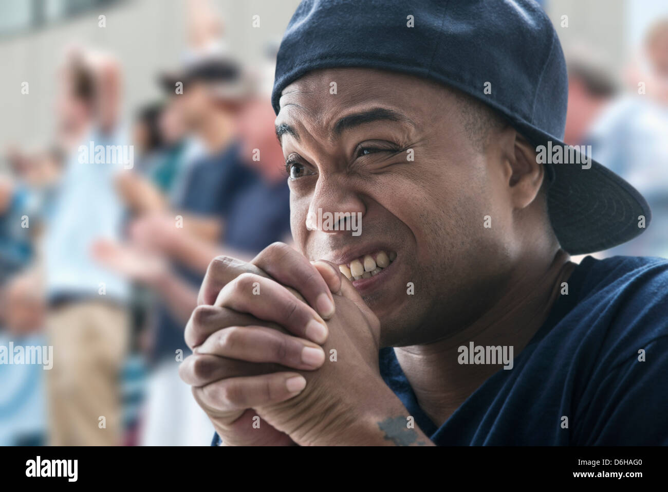 Tense man at sports game Stock Photo - Alamy