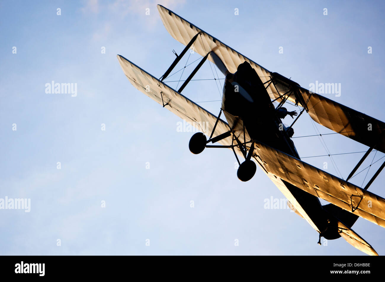 Biplane flying with blue sky in background Stock Photo - Alamy