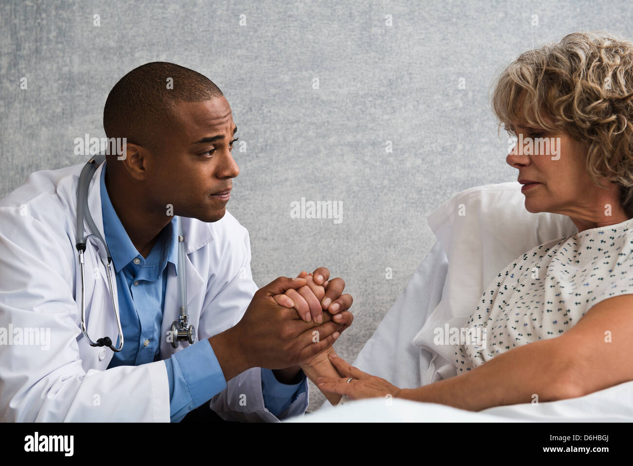 Doctor holding patient's hand Stock Photo - Alamy