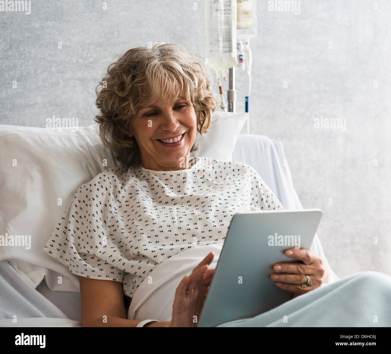 Female hospital patient using digital tablet Stock Photo - Alamy
