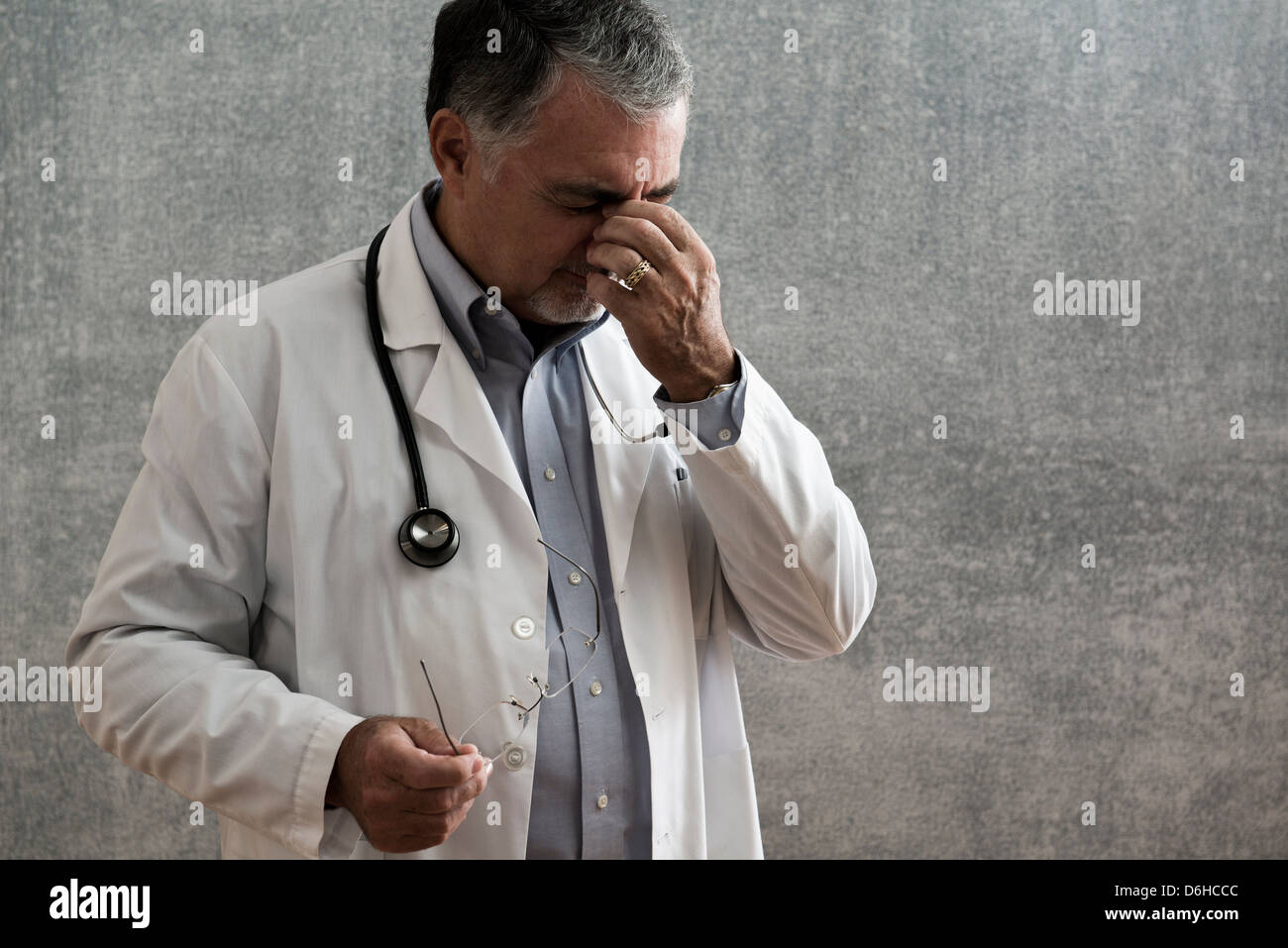 Male doctor looking stressed Stock Photo - Alamy