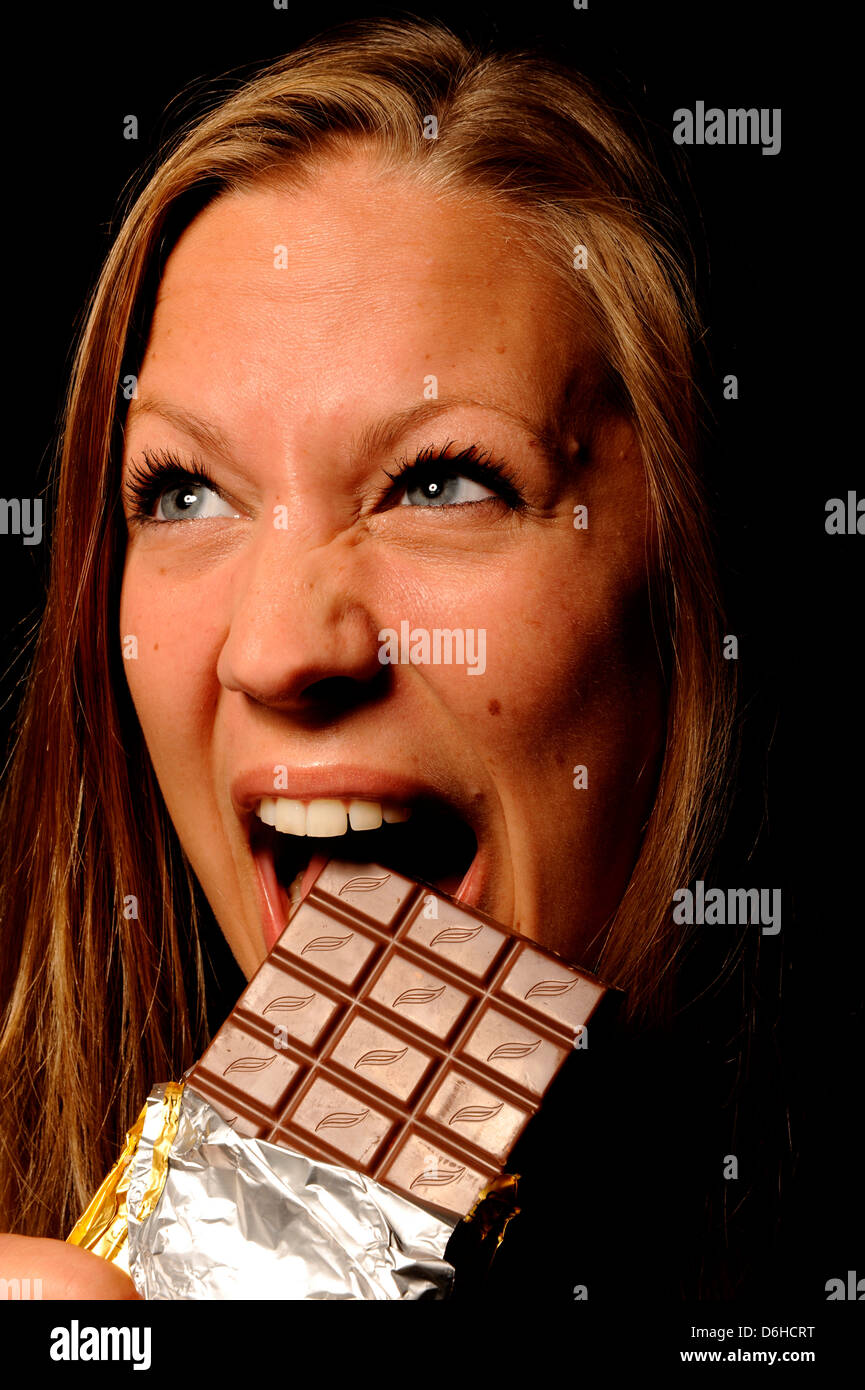 Black woman eating chocolate bar hi-res stock photography and images ...