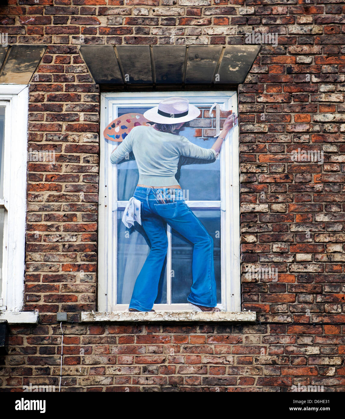 painting on the facade of a building where a window was bricked up to ...