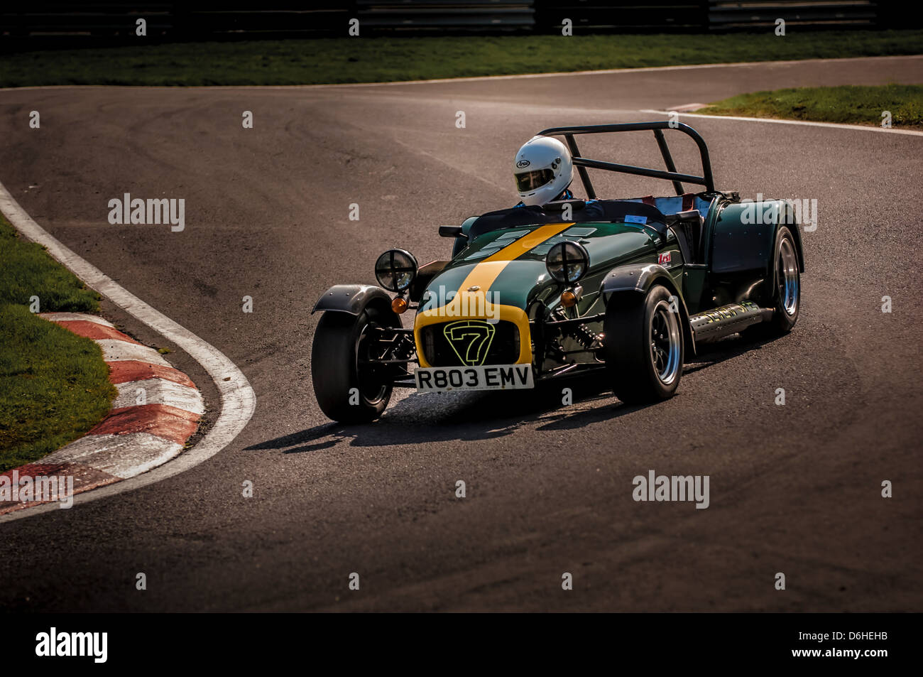 Front and side view of a green and yellow Caterham Seven car racing at ...