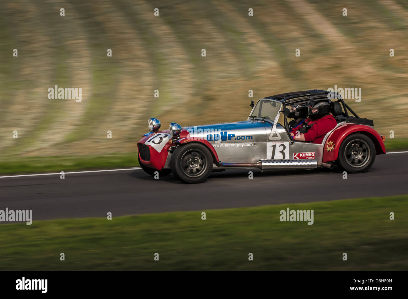 Side view of a Caterham car racing at Cadwell park racetrack, on sunny ...