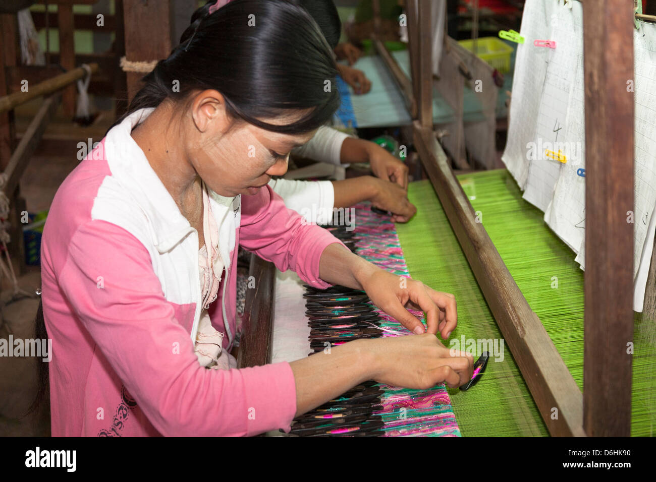 Woman weaving on a loom, Thein Nyo silk weaving workshop, Amarapura ...