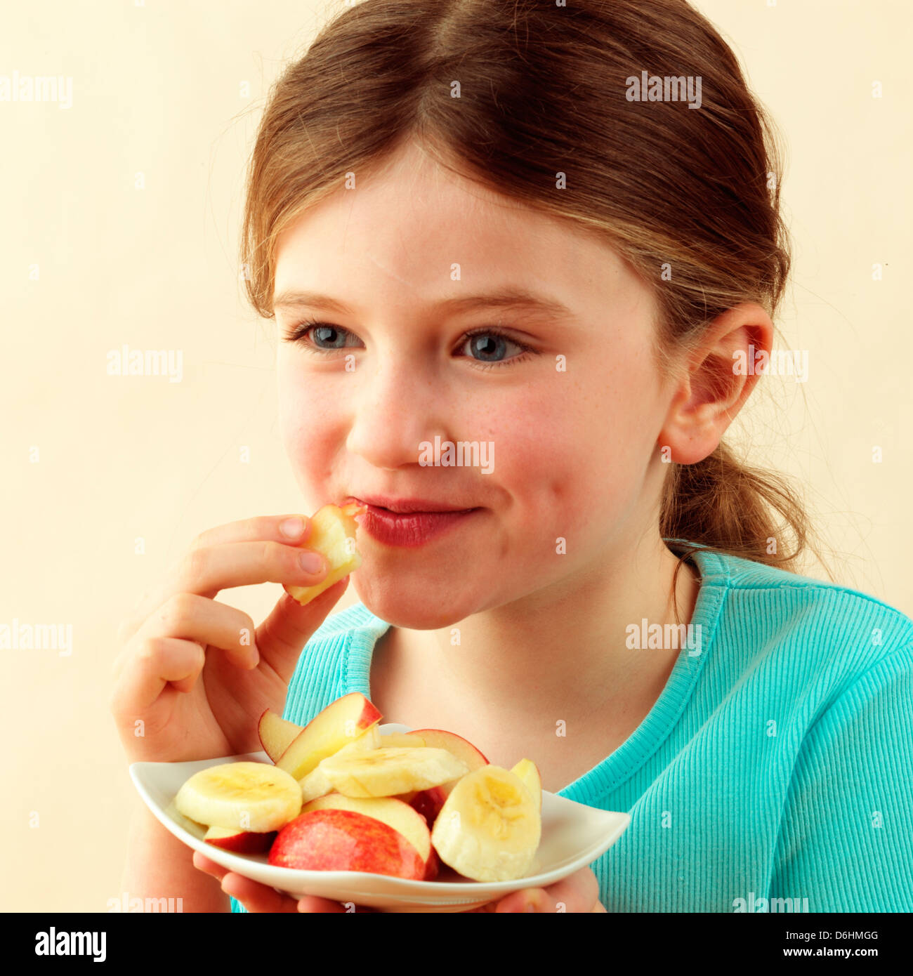 Child eating fresh fruit Stock Photo - Alamy