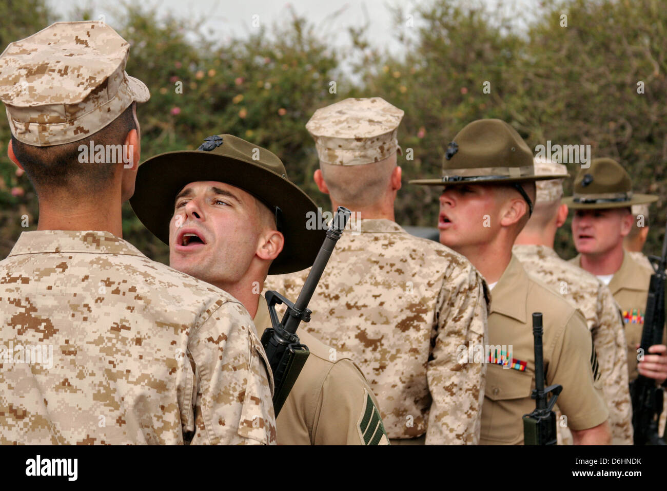 A US Marine Corps recruit responds to the screaming challenges of a ...