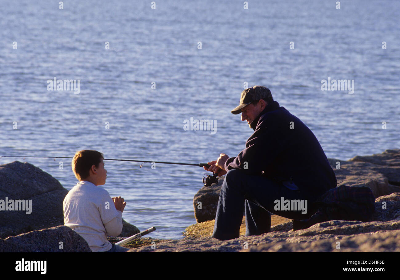 Young boy and grandfather fishing on the jetties at Port Aransas Texas ...