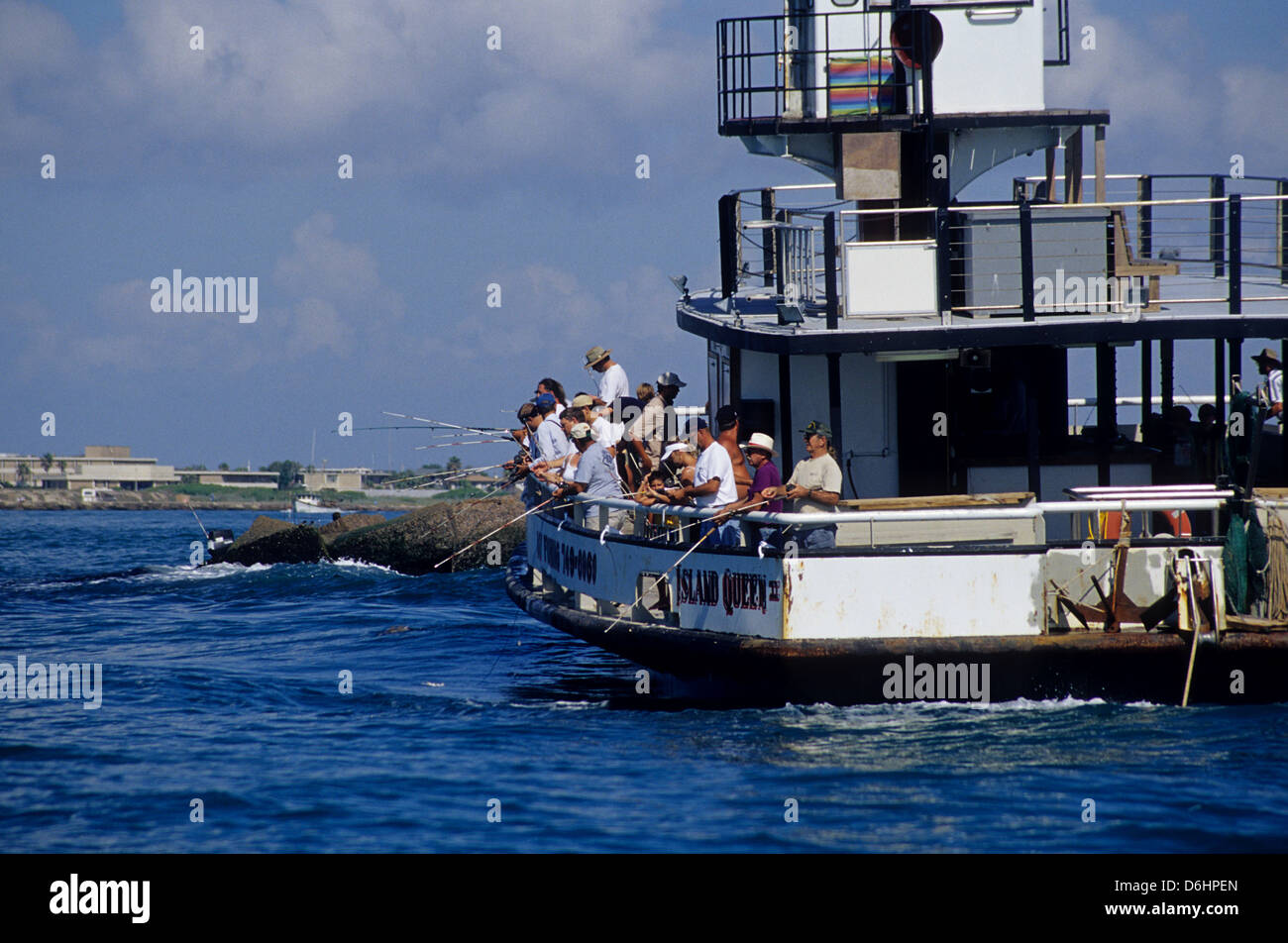 Tourists fishing from a party boat near the jetties at Port Aransas ...