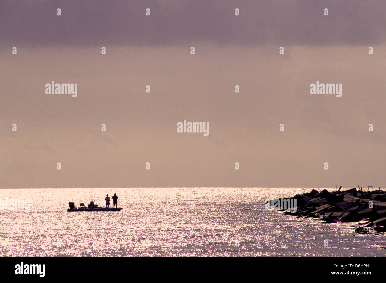 Boat and fishermen approaching the jetties at Port Aransas Texas Stock ...