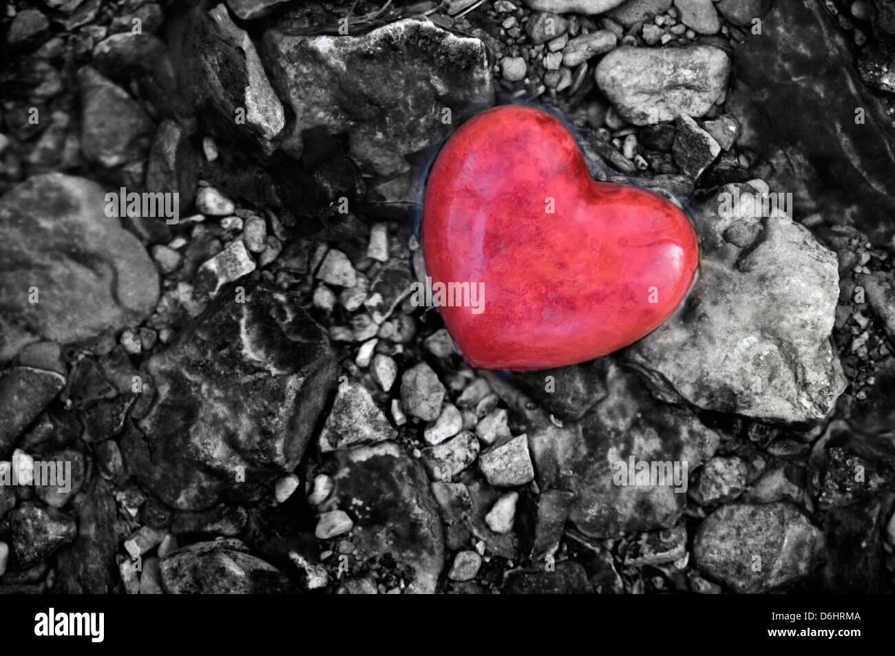 Red Stone Heart Amid Pebbles in a Stream Stock Photo - Alamy