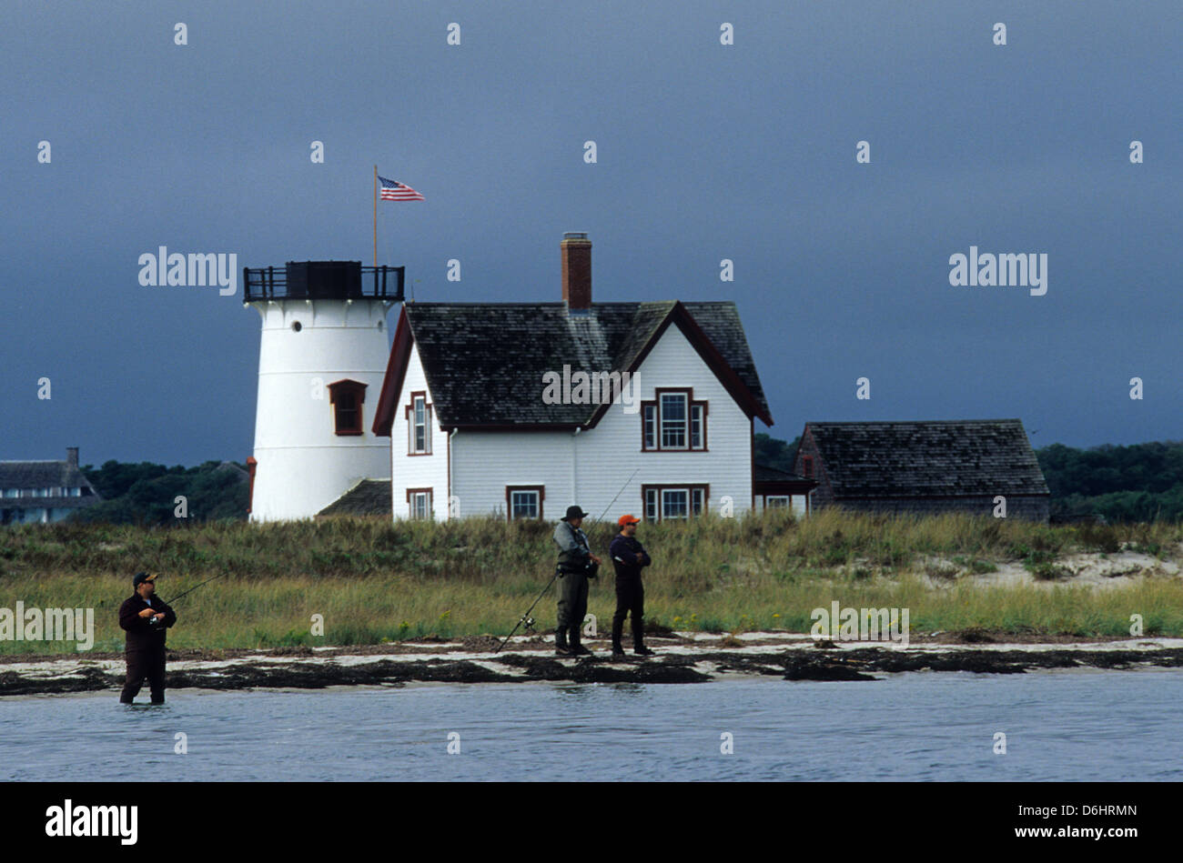Fisherman on the beach near the lighthouse at Chatham Cape Cod ...