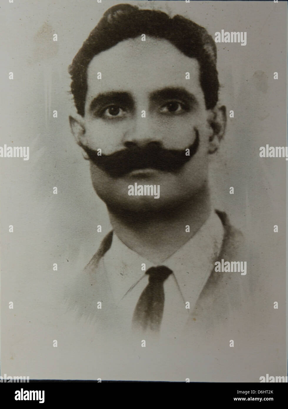 This image features a man with a prominent mustache, captured during ...