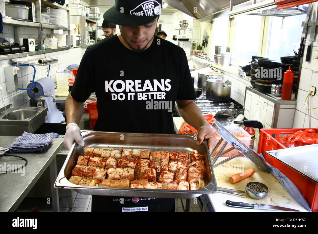 A cook displays spicy cabbage salad, the South Korean national dish ...