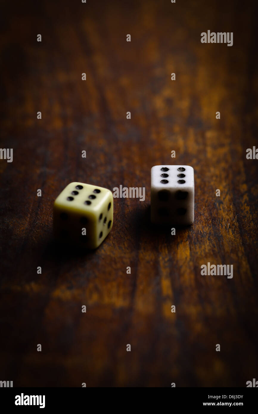 Two dice displaying six on a vintage wood plank Stock Photo - Alamy