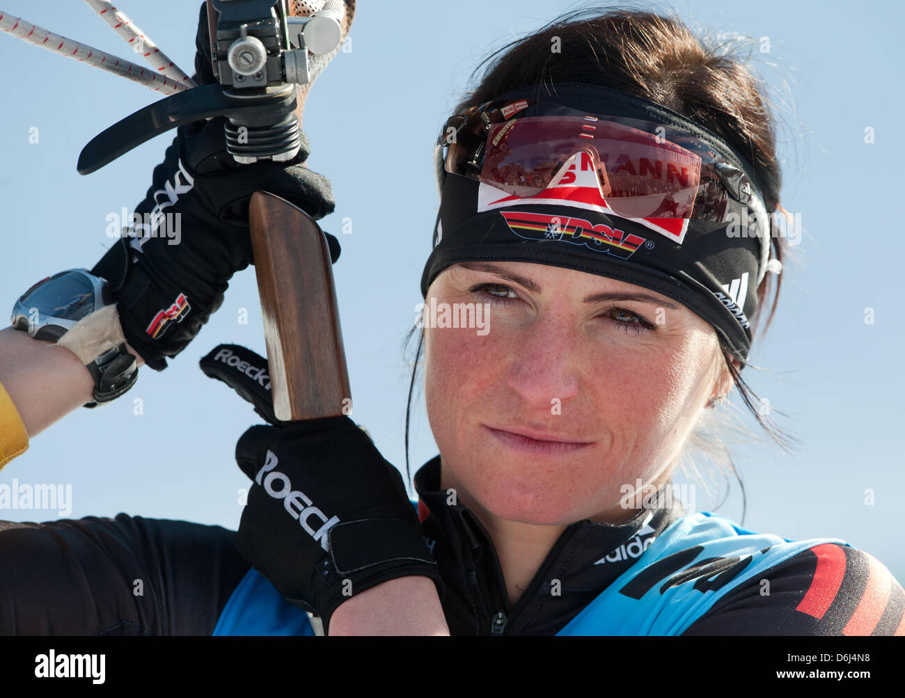 German biathlete Andrea Henkel lifts her rifle during training for the ...