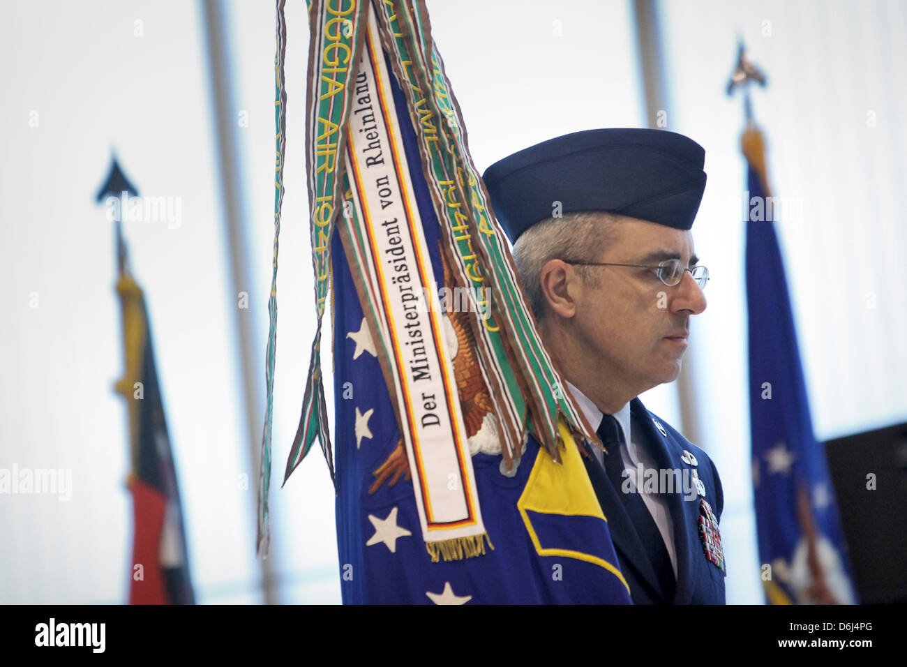 A soldier carries the flag of the 86th transport squadron in a hangar ...