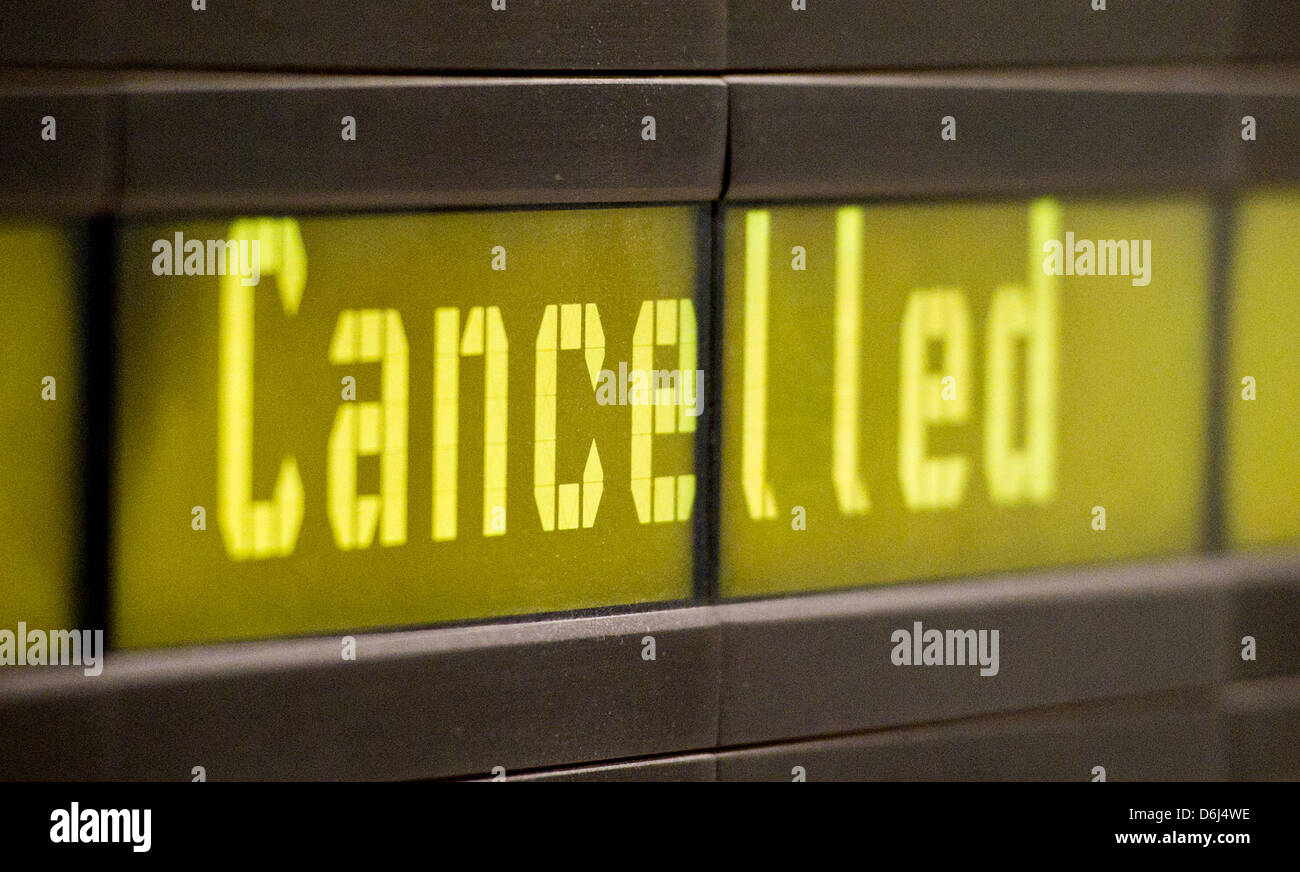 Cancelled is written on a display board at Berlin-Schoenefeld Airport ...