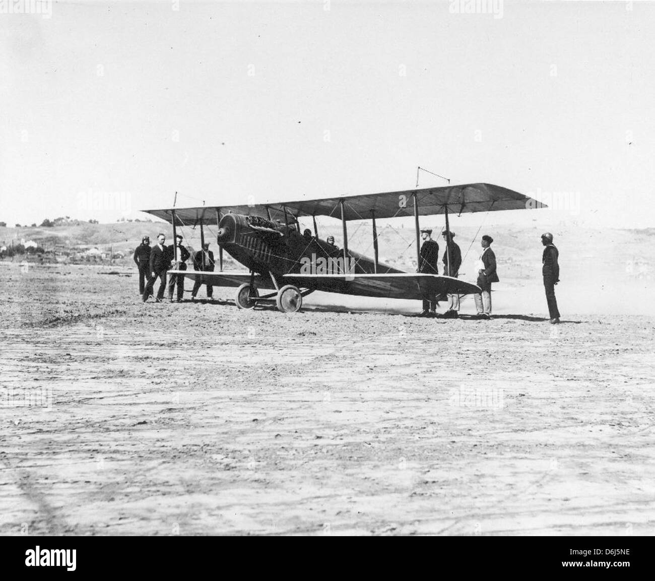 This photo captures people gathered around a Curtiss JN-4 Jenny ...