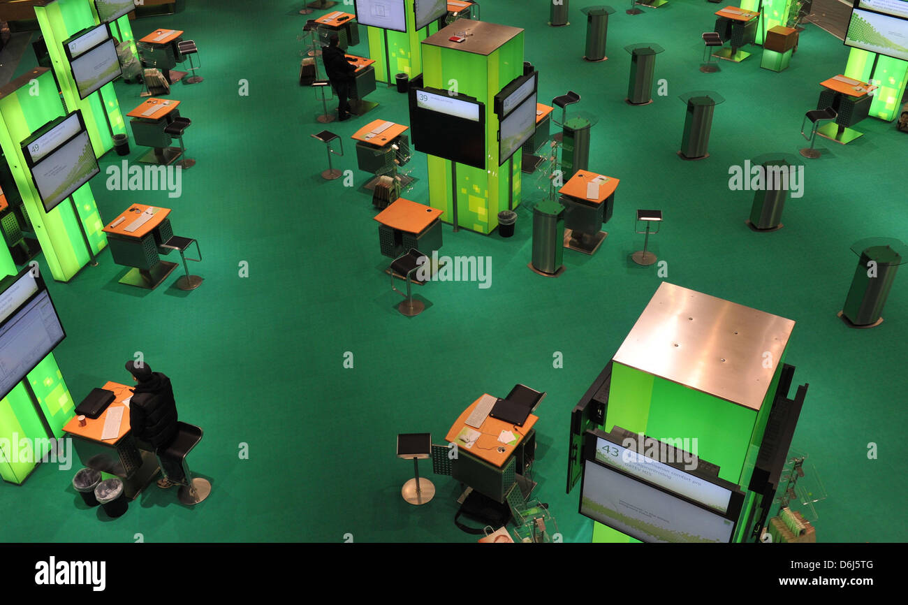 Datev employees meet at their company's stand during the setup of the ...