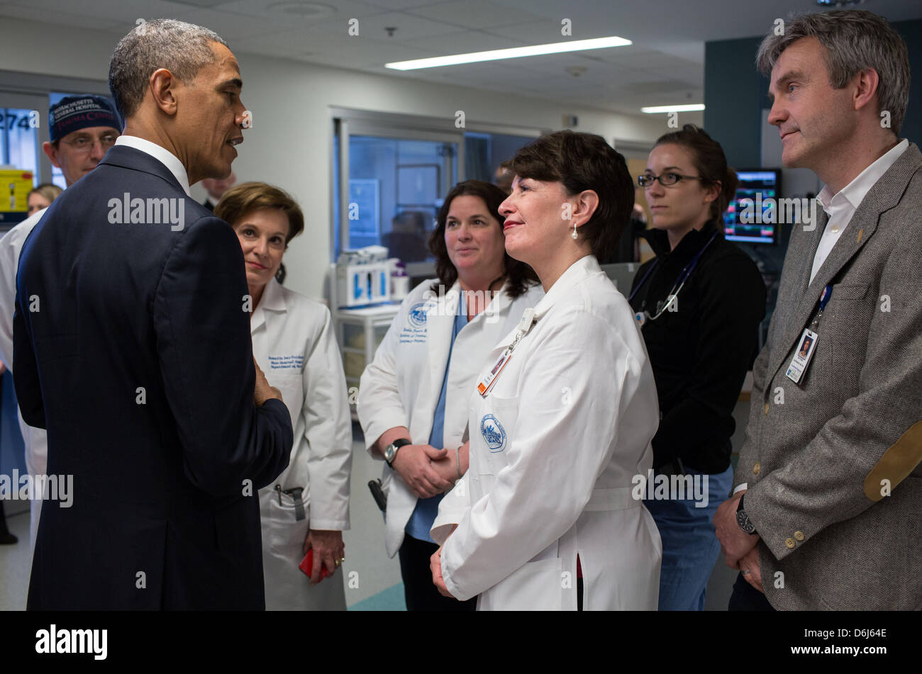 HANDOUT - United States President Barack Obama talks with staff at ...