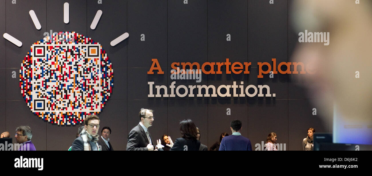 IBM staff members stand at their booth at the world's largest computer ...