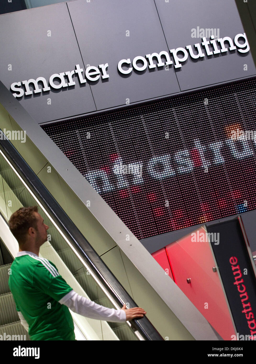IBM staff members stand at their booth at the world's largest computer ...