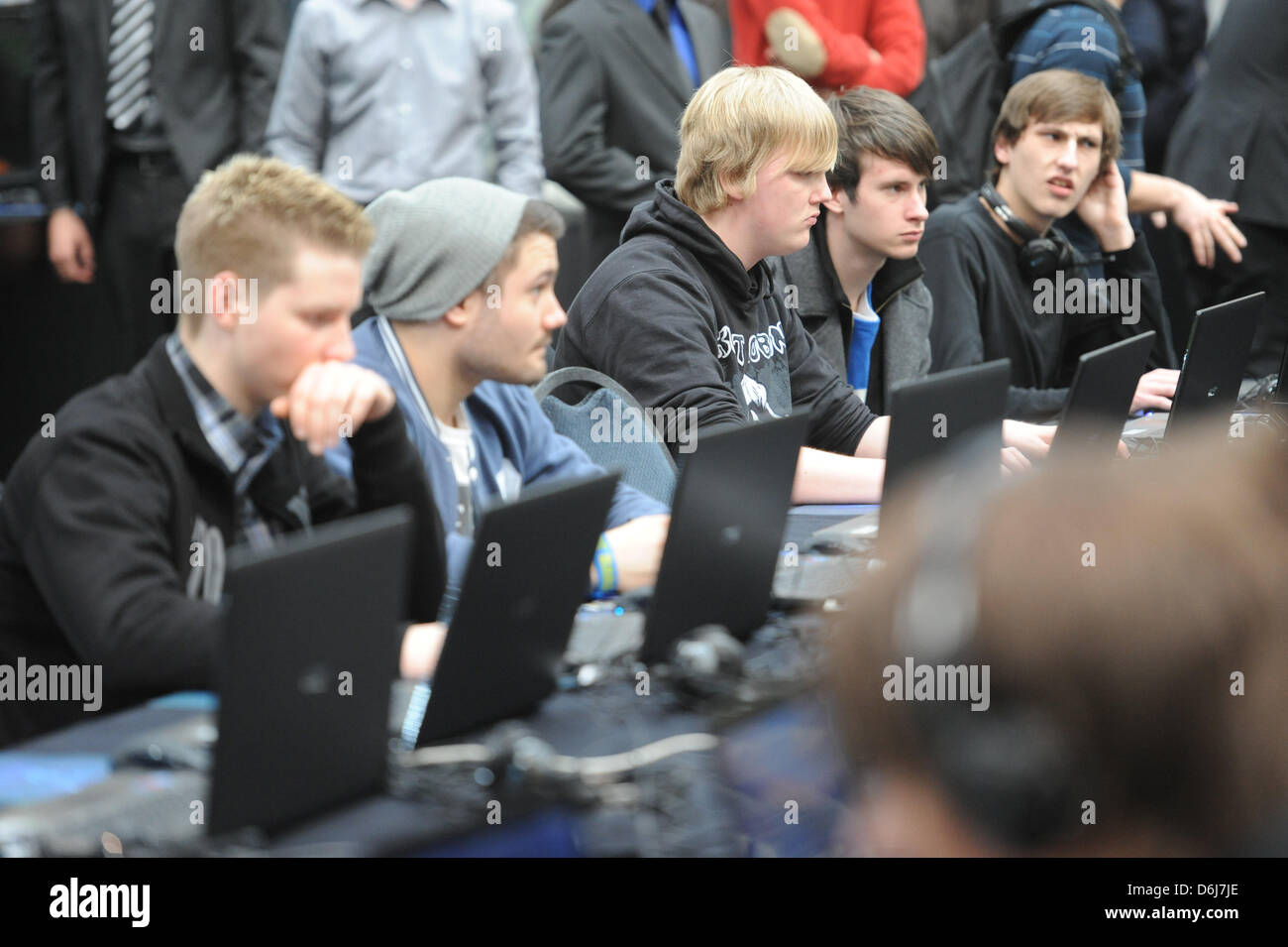 Visitors sit in front of their laptops at the information technology ...