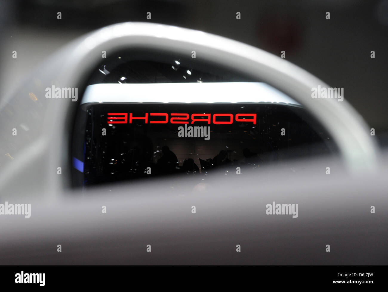 The Porsche lettering is reflected in a mirror of a Porsche 911 at the ...