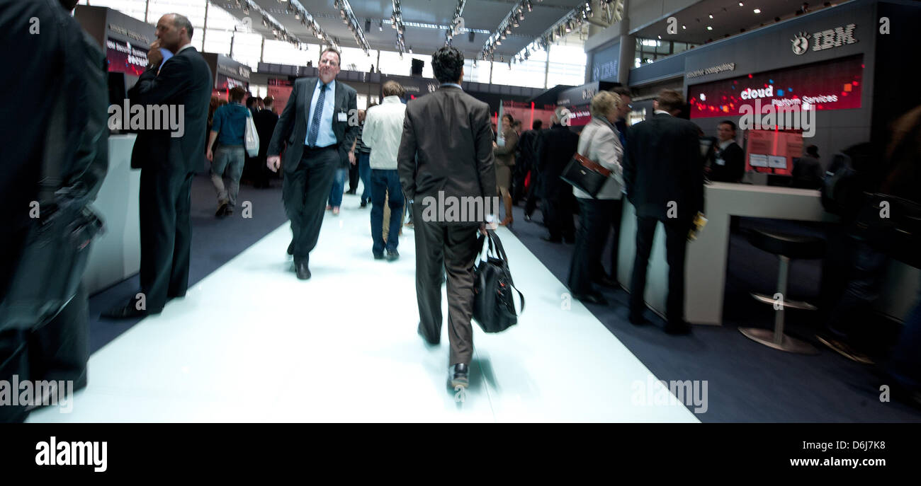 Visitors walk by the IBM booth at the information technology fair CEBIT ...