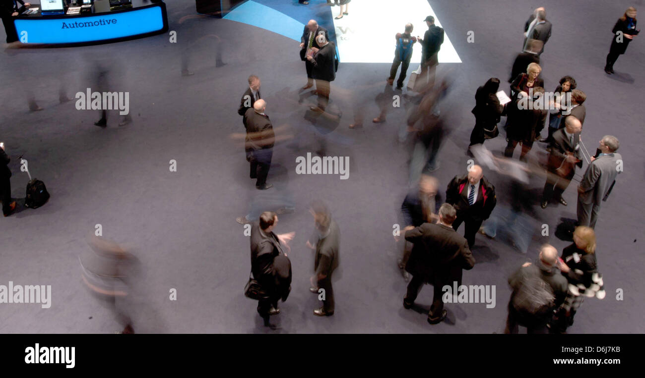 Visitors walk by the IBM booth at the information technology fair CEBIT ...