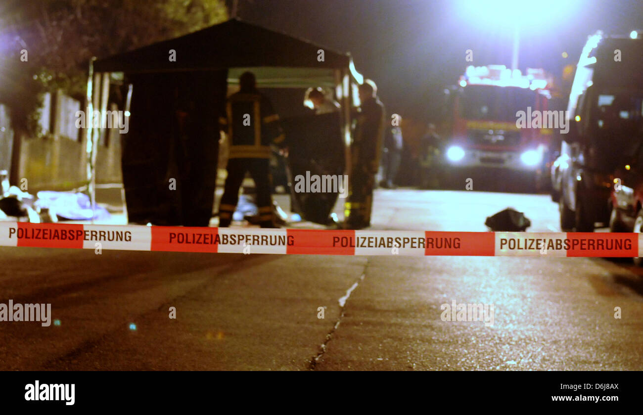 Forensics officers investigate the crime scene where a wife shot her ...