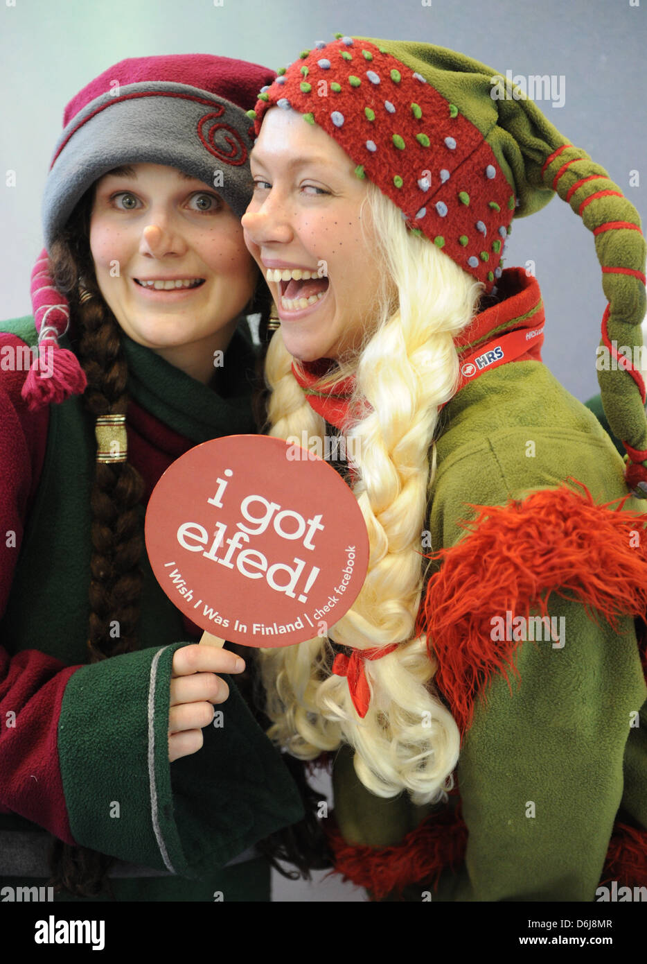 Finnish hostesses Dorilina (L) and Juliana dressed as Christmas elves ...