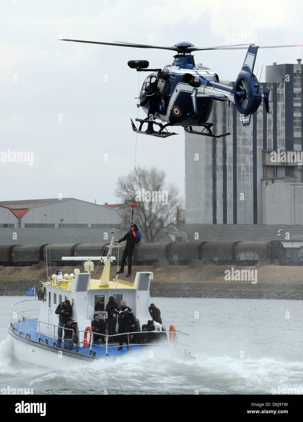 A diver of the French police is roped down on a police boat during a ...