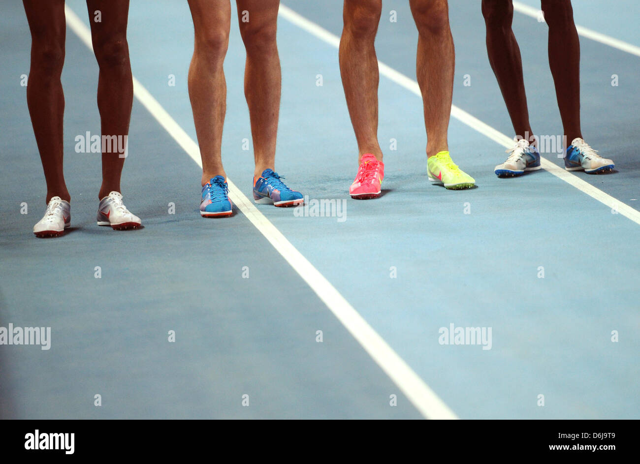 Ryan Foster of Australia (2nd R) wears different coloured runnig-shoes ...