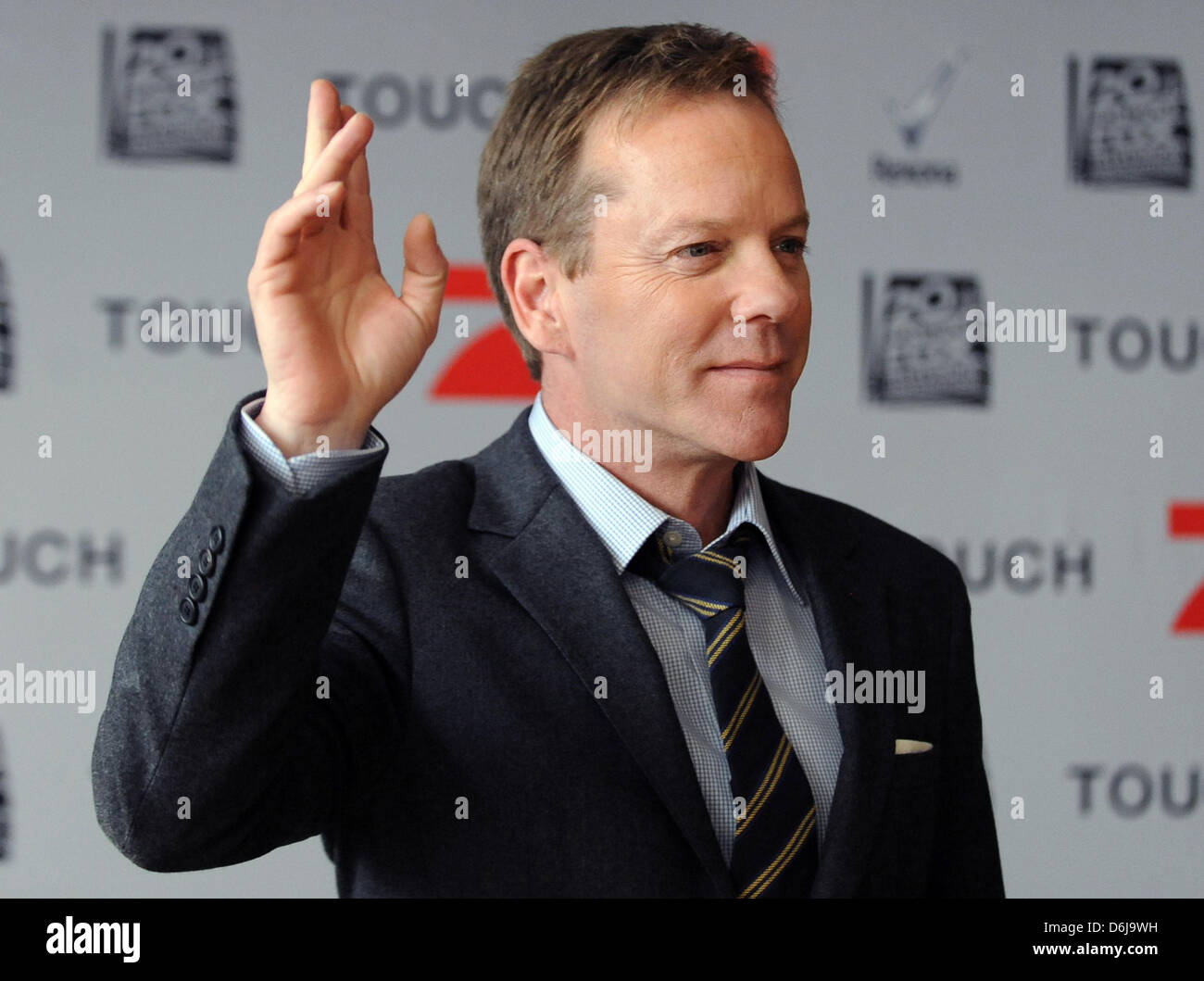 Canadian actor Kiefer Sutherland waves as he attends a photocall for ...