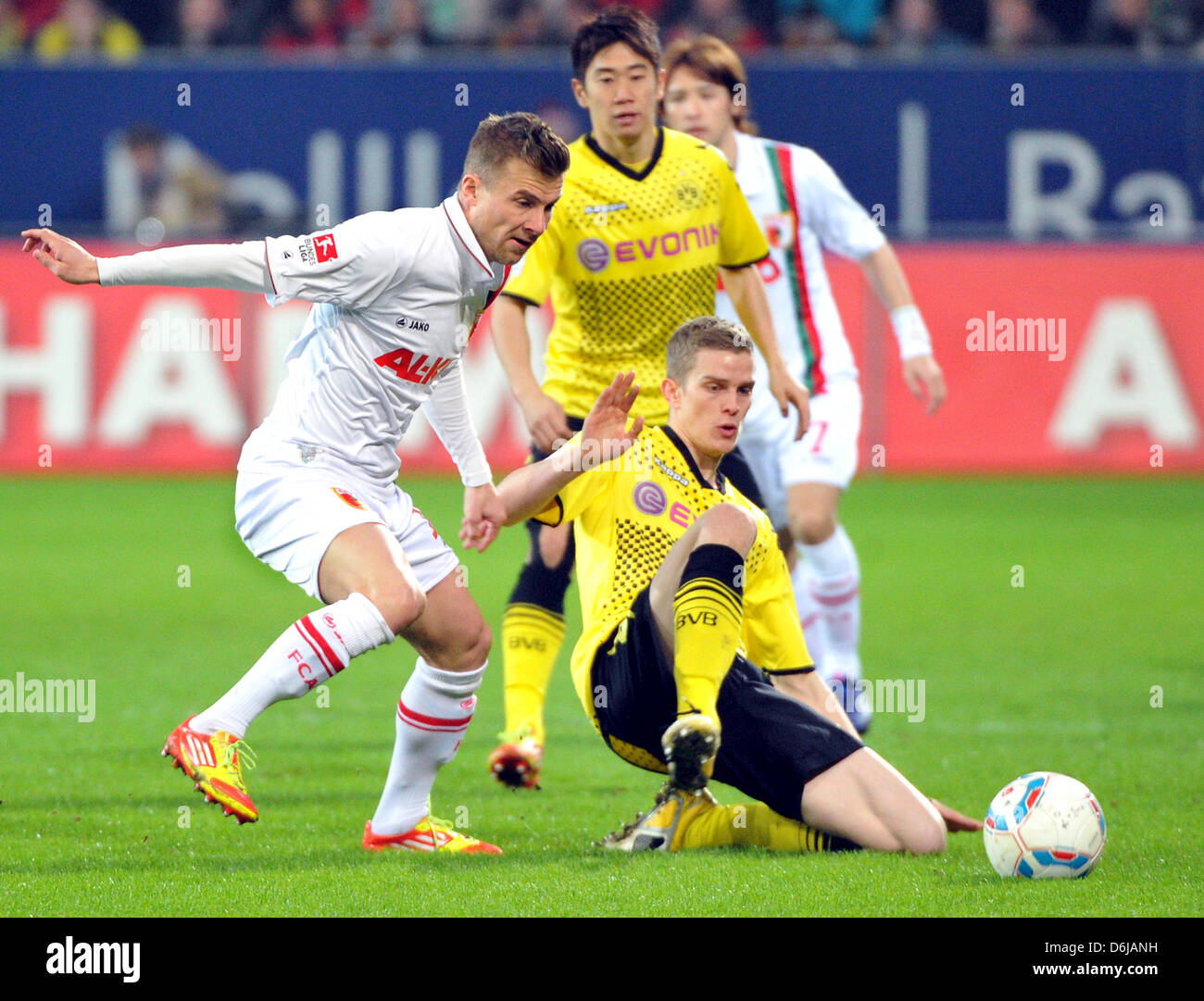 Augsburg's Daniel Baier vie for the ball with Dortmund's Sven Bender (R ...