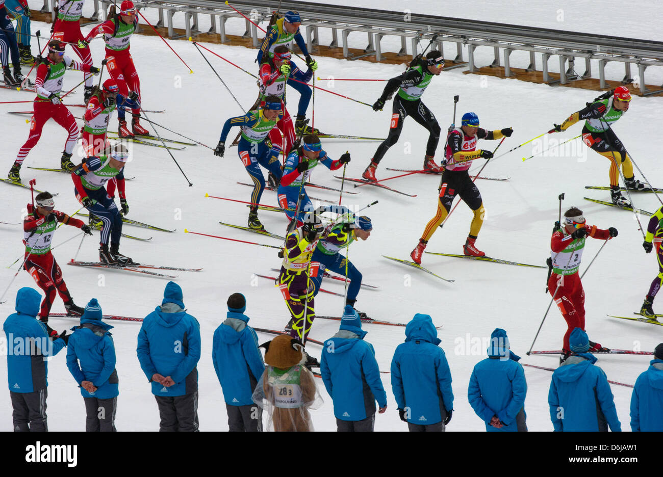 Biathletes race along the course at the beginning of the men's 15km ...