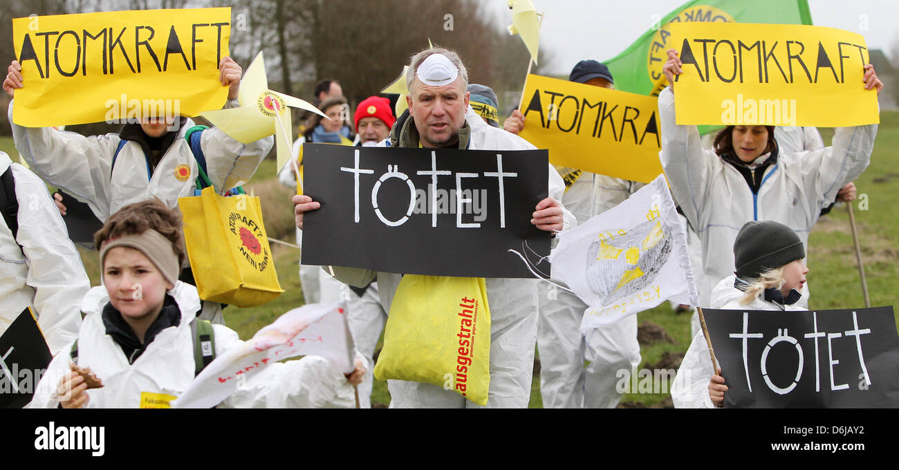 People protest against nuclear energy with posters during a ...