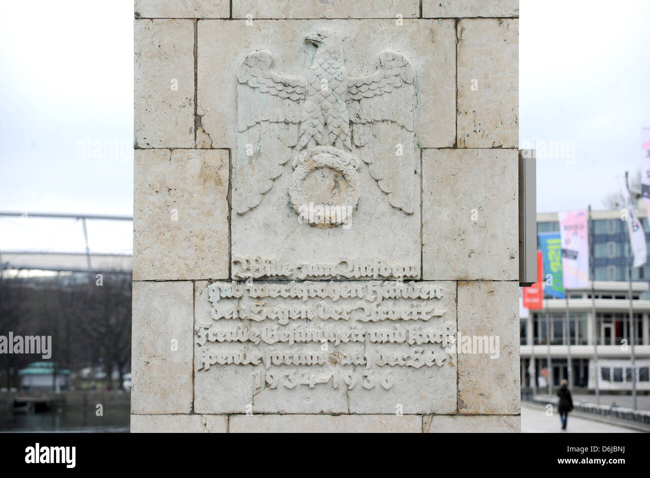 An imperial eagle holding a wreath (with a removed swastika) is carved ...