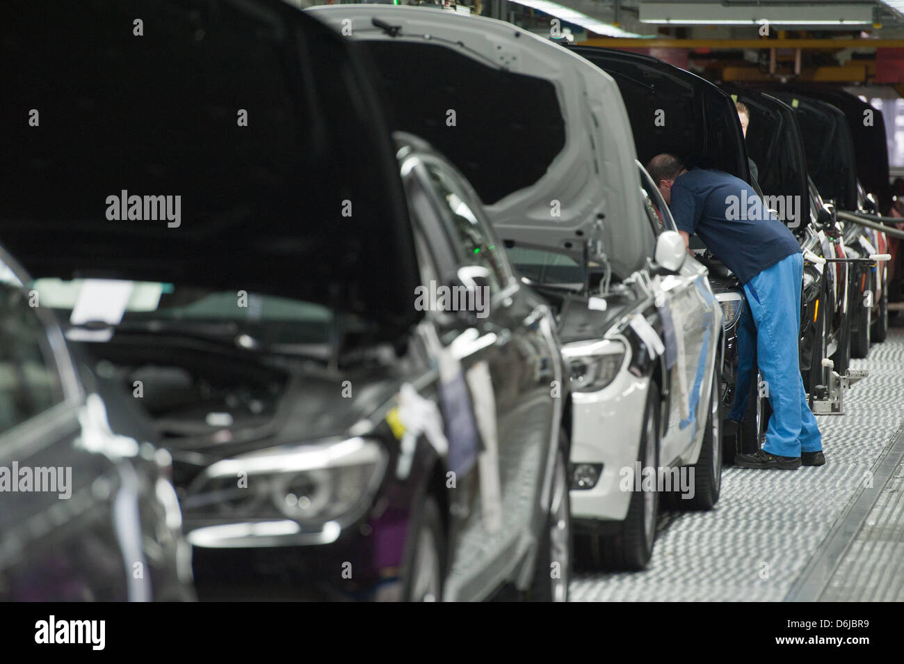 A BMW employee works on a BMW inside the company's plant in Dingolfing ...
