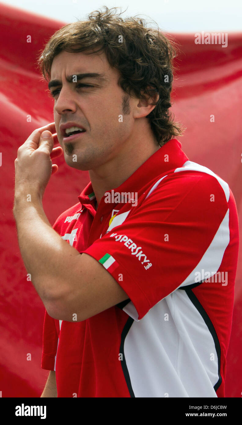Spanish Formula One driver Fernando Alonso of Ferrari walks through the ...