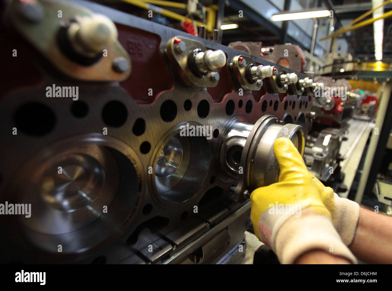 A member of staff of German engine manufacturer Deutz AG pushes a ...