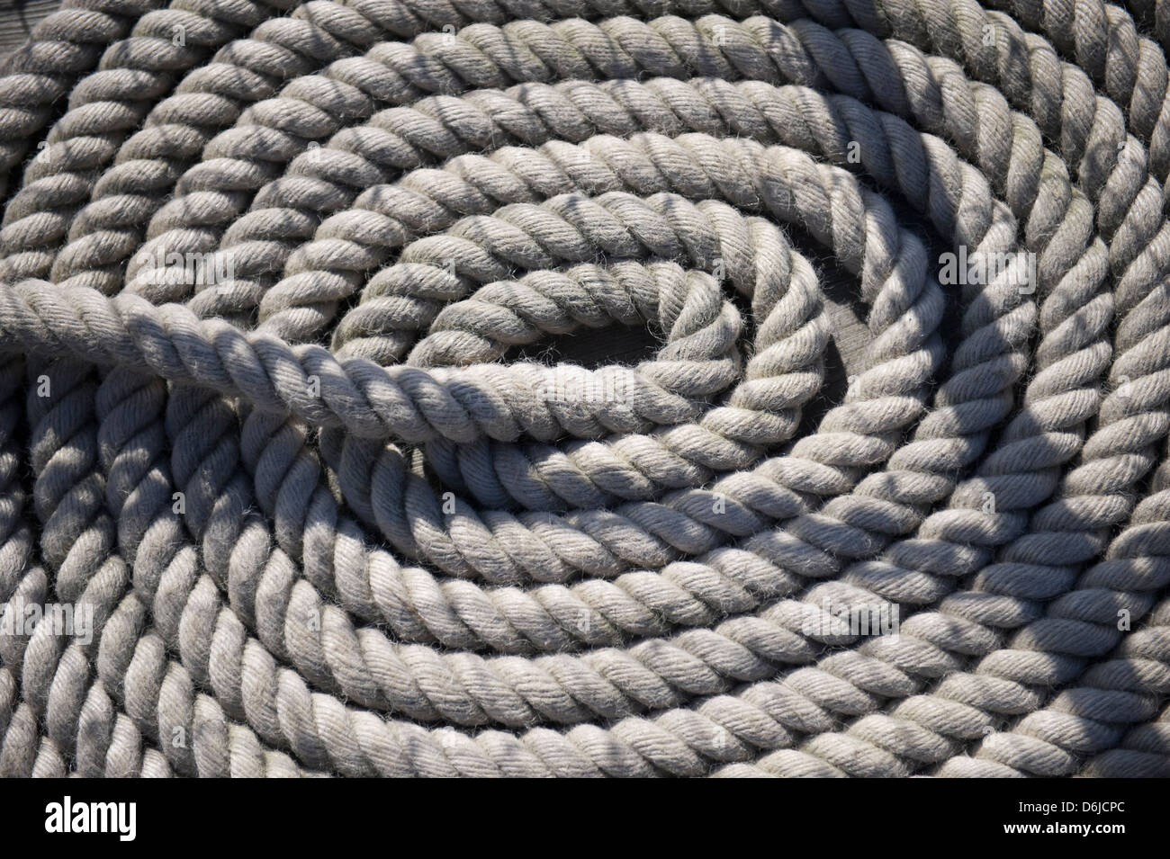 Neatly placed rope on ships deck Stock Photo - Alamy