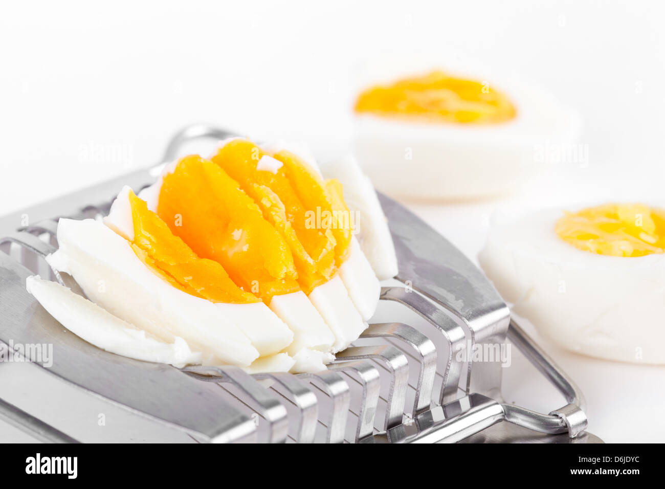 Cutted egg on cutter, closeup on white Stock Photo - Alamy